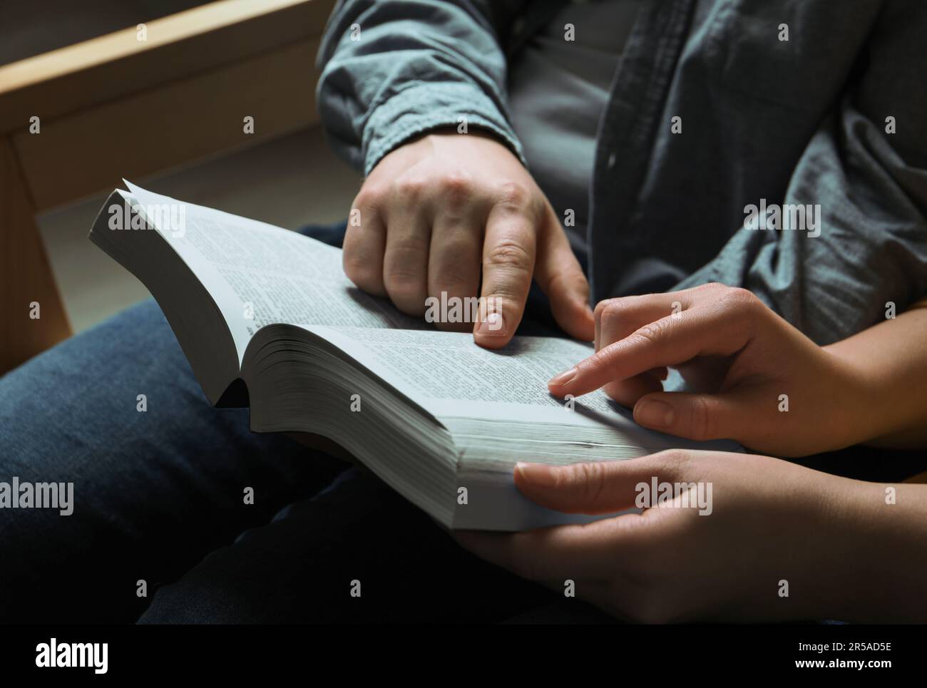 Couple sitting and reading holy Bible indoors, closeup Stock Photo - Alamy