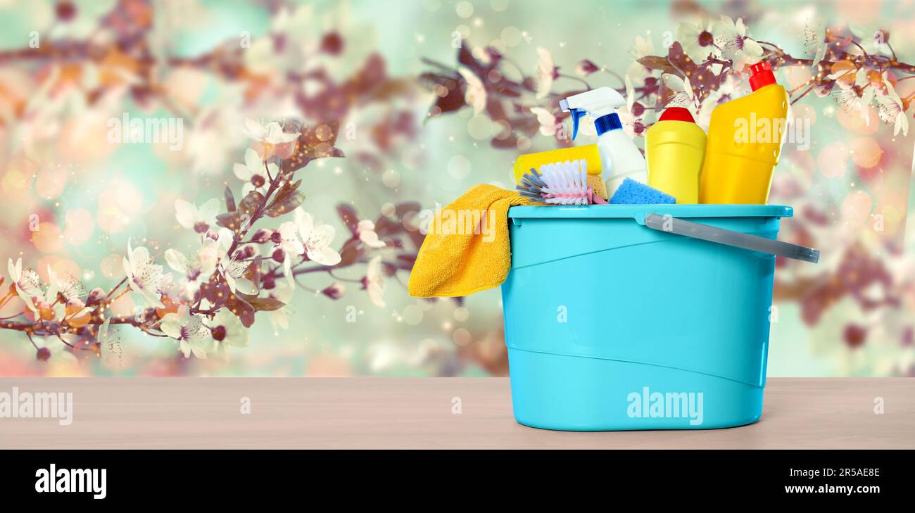 Spring cleaning. Bucket with detergents and tools on wooden surface ...