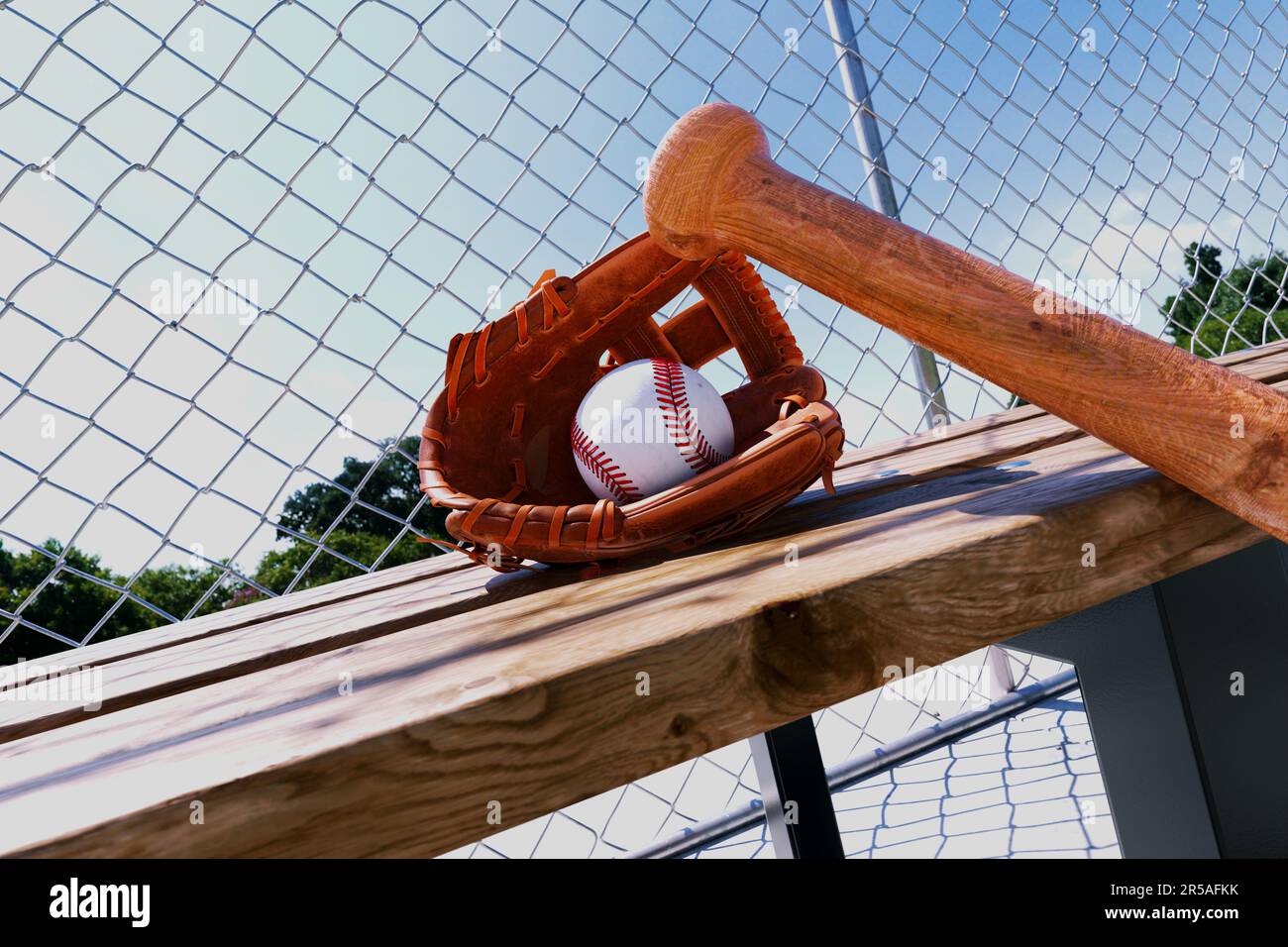 Baseball glove with ball and bat at a wooden bench. Baseball ...