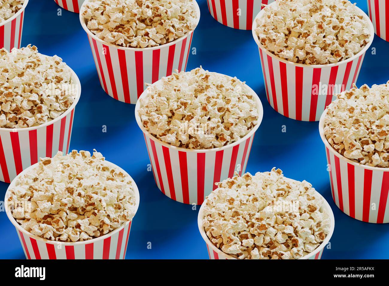 Red and white striped buckets full of popcorn. Paper boxes filled with ...