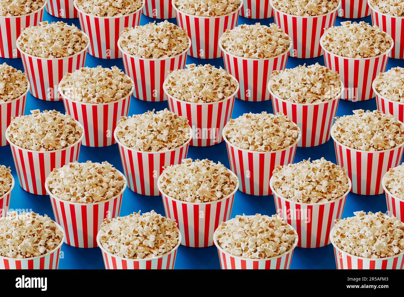 Red and white striped buckets full of popcorn. Paper boxes filled with ...