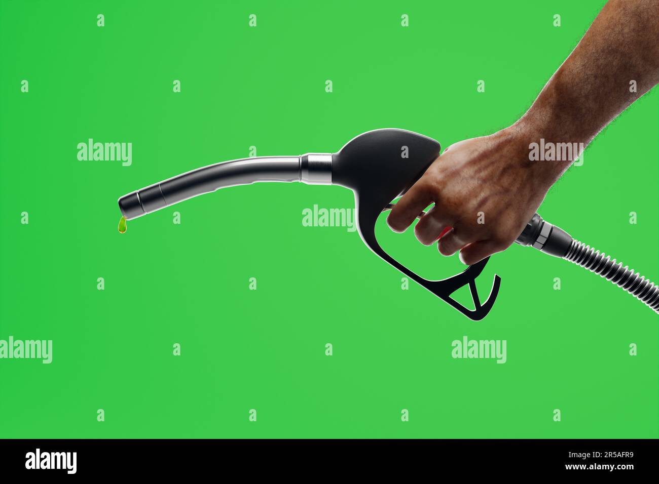 The last drop of petrol. A man's hand holding a fuel pump nozzle on the ...