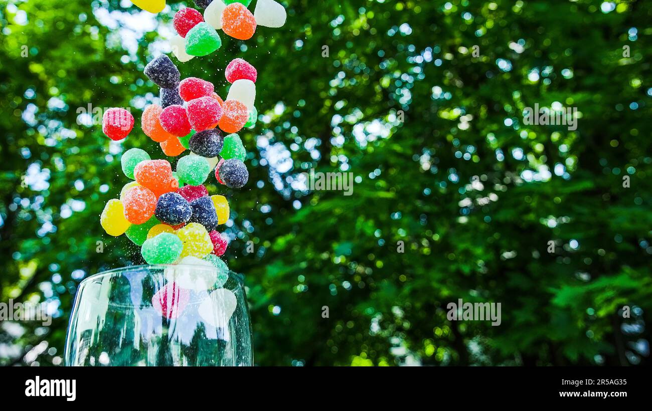 Colorful candy flying out from inside glass outdoor Stock Photo - Alamy