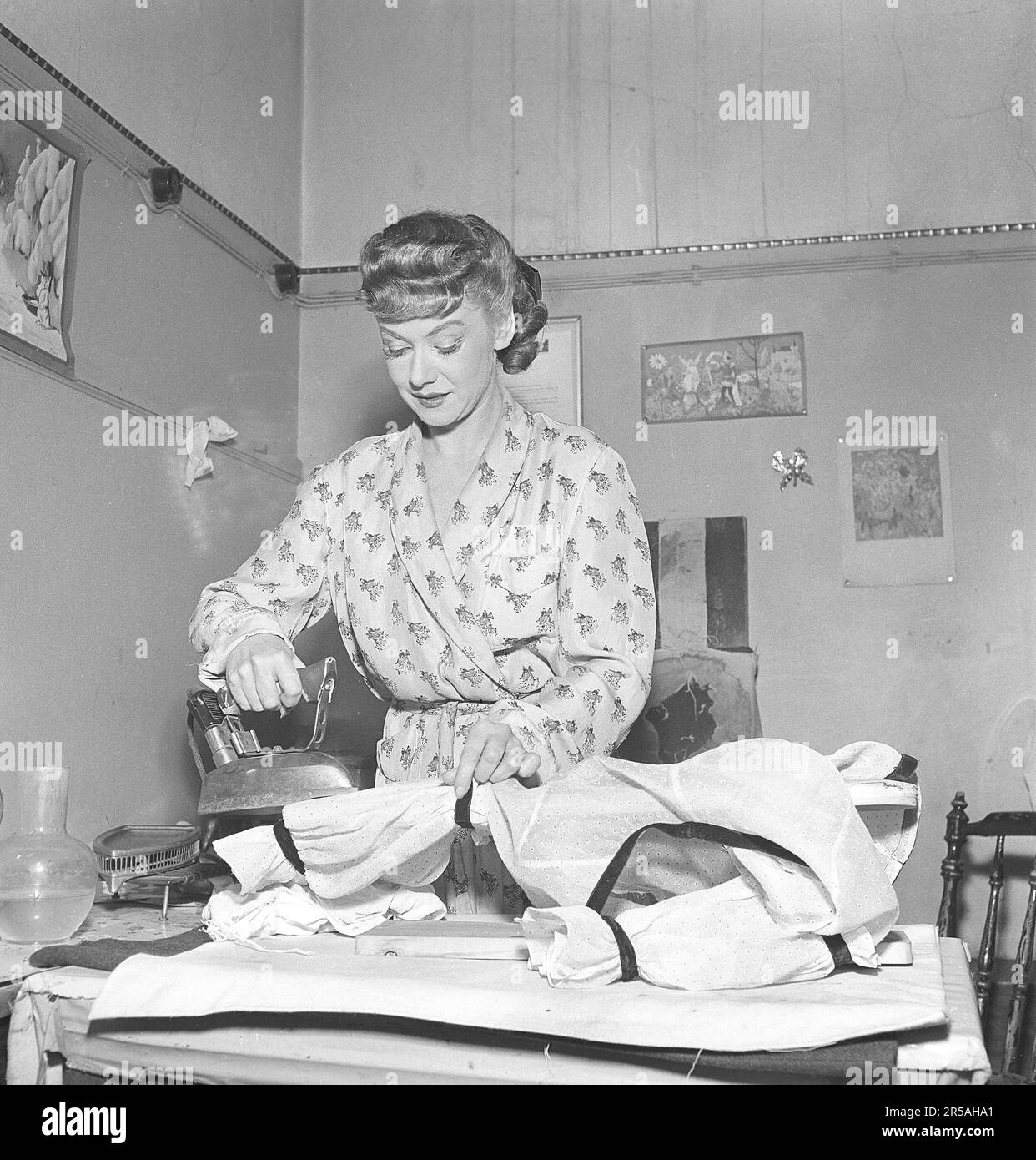 Ironing in the 1950s. A woman seen ironing her clothes. She is actress Sonja Wigert 1913-1980 ...