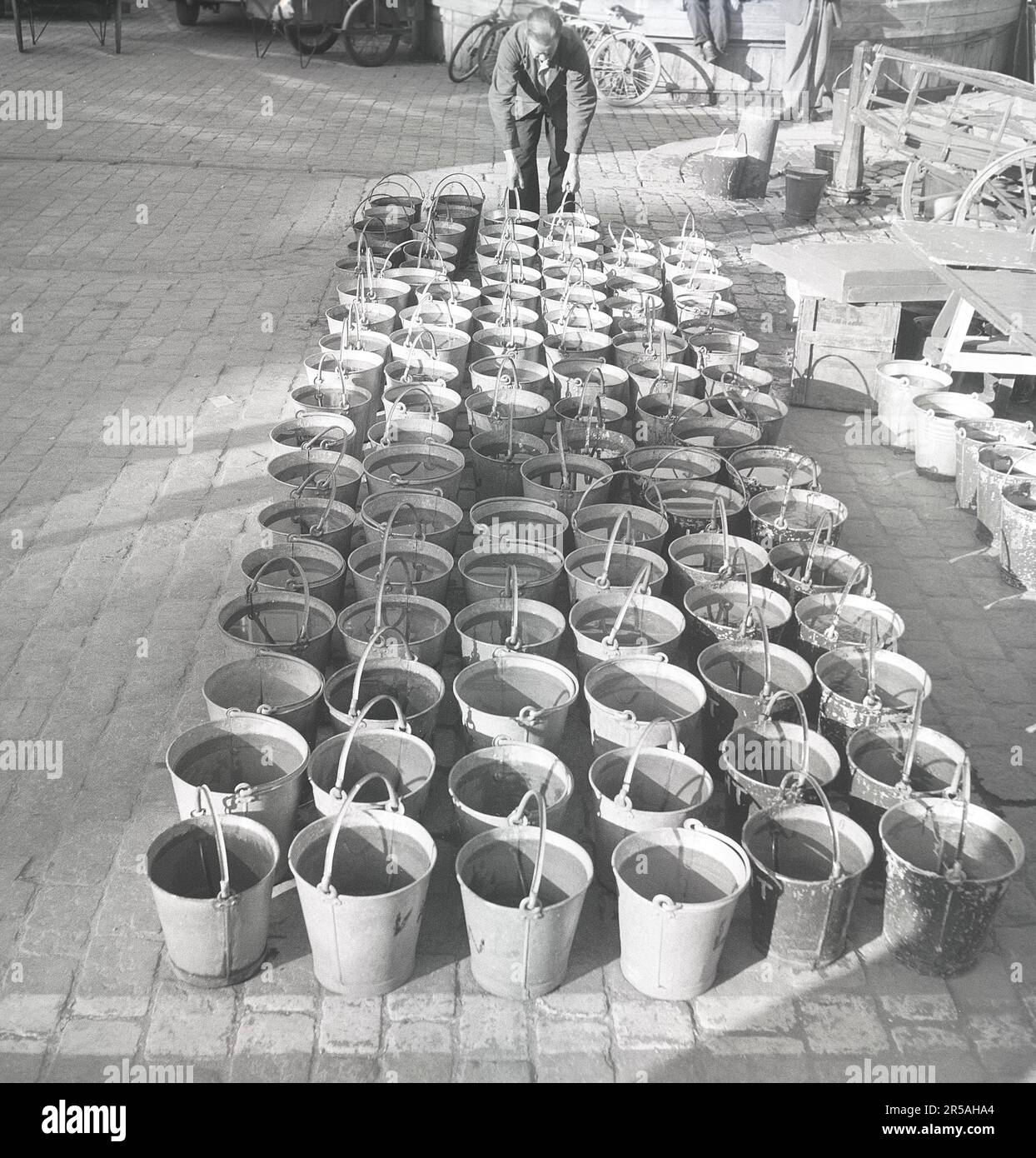 Buckets. More than a hundred buckets of water placed in the street with ...