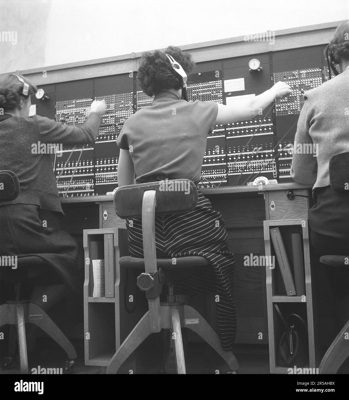 Telephony in the 1950s. Women working at a telephone switchboard as it ...
