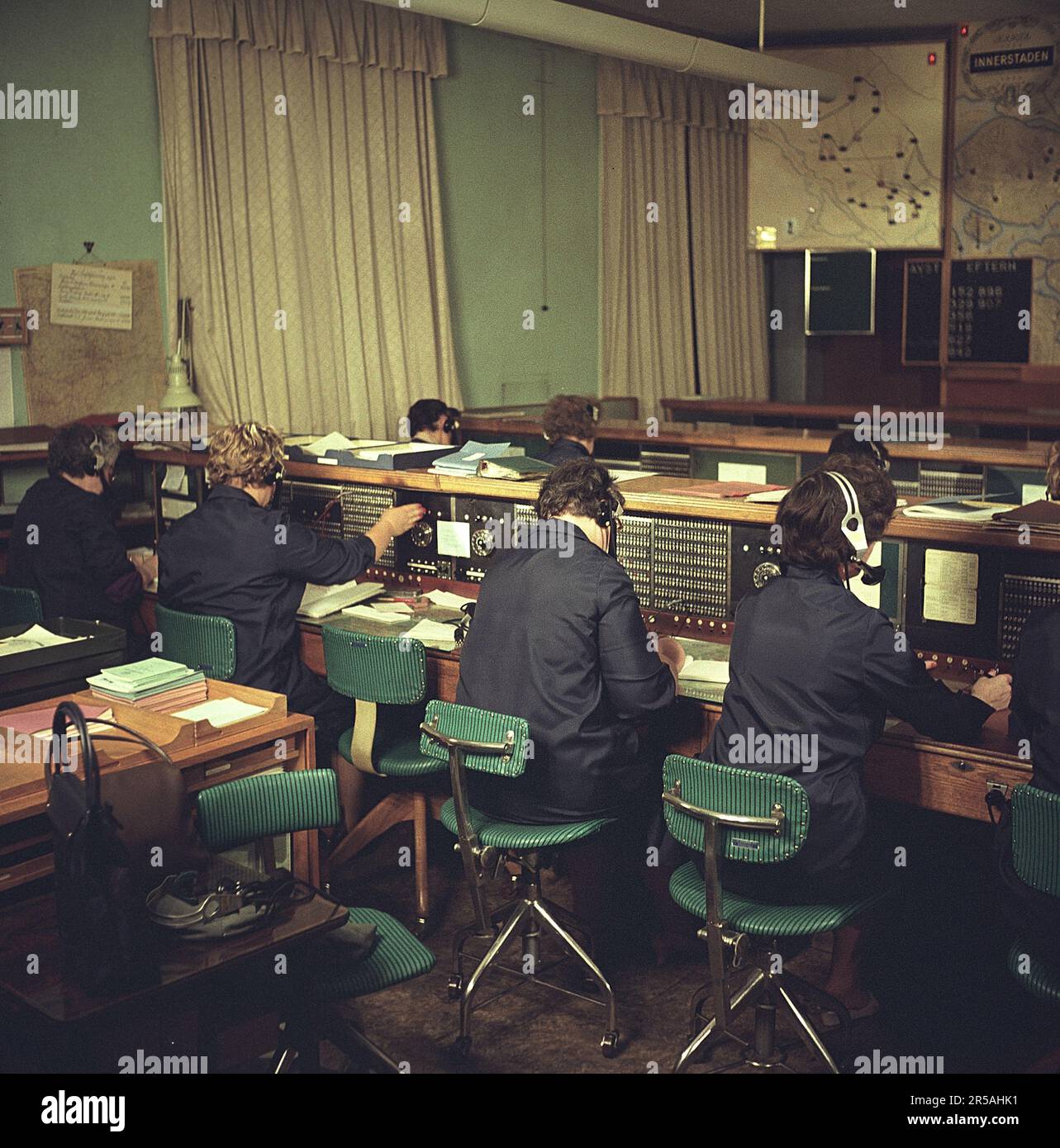 Telephony in the 1950s. A woman working at a telephone switchboard as ...