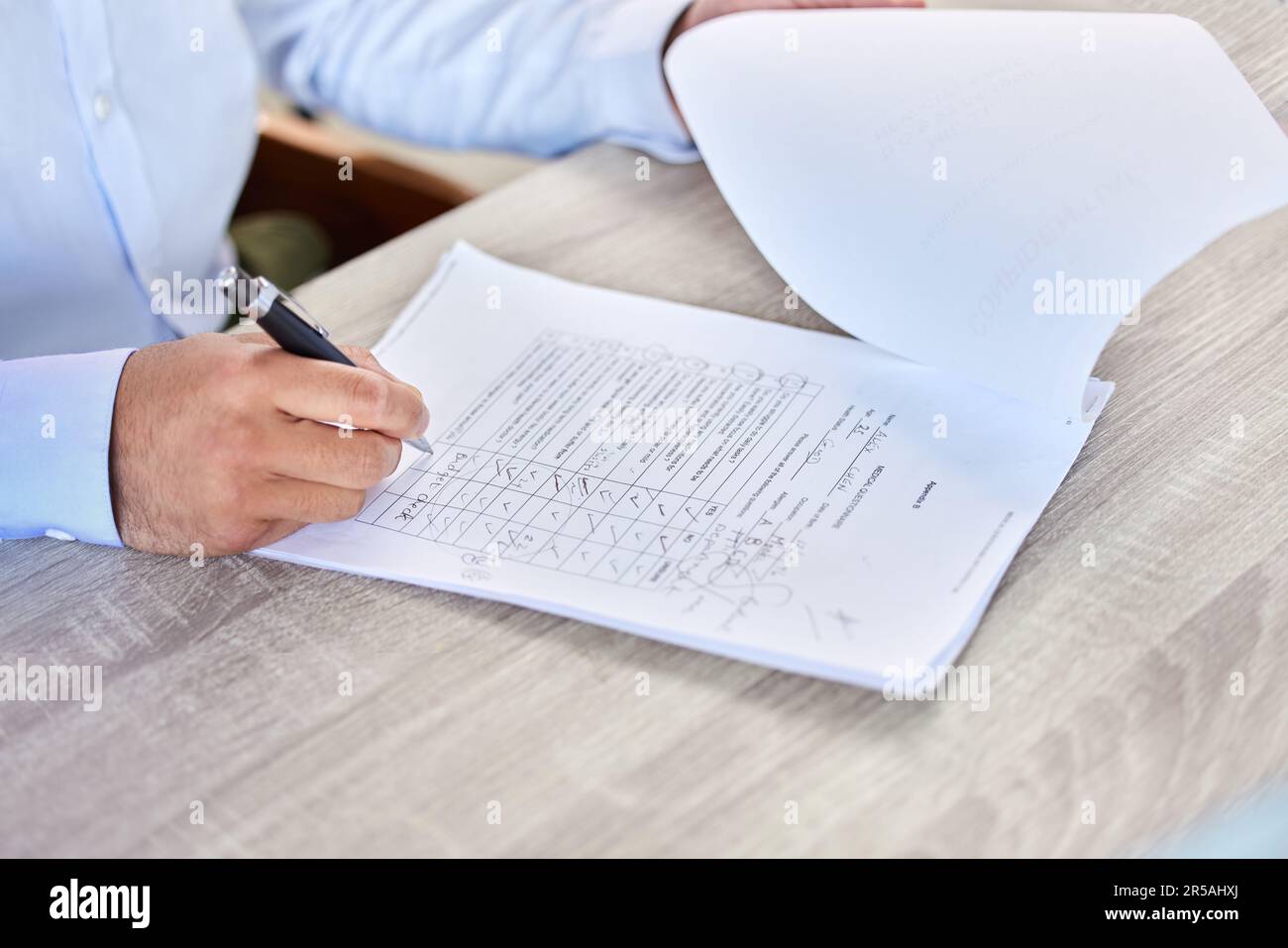 Man, hands and writing on medical questionnaire, paperwork or ...