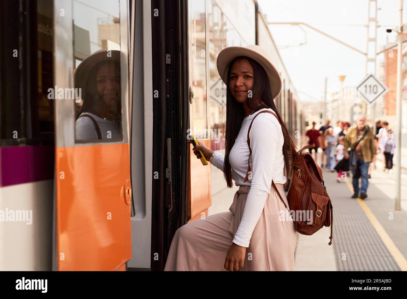 African American woman traveler boarding a train to go on vacation ...