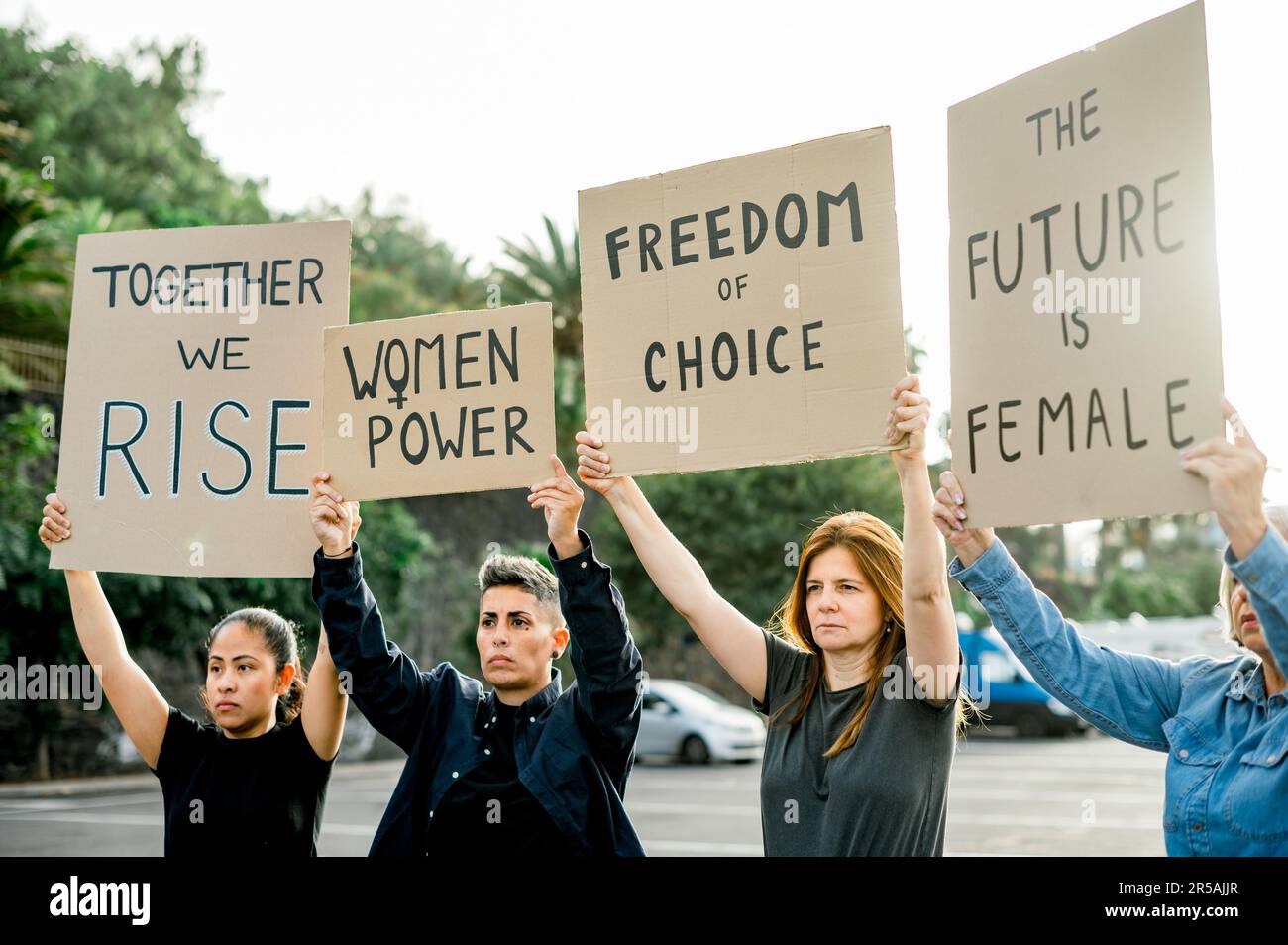 Serious female protesters with placards Stock Photo - Alamy
