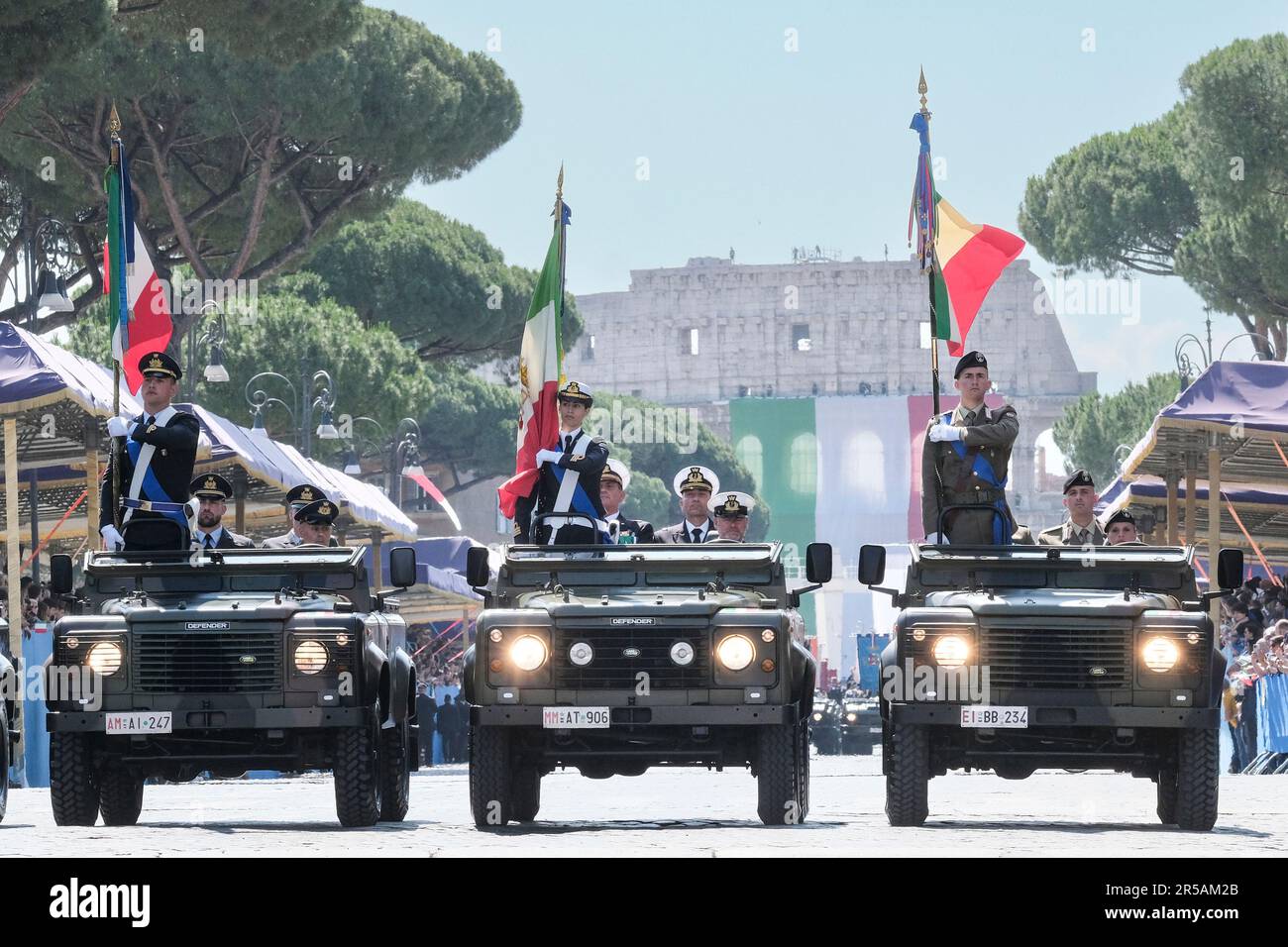 Military vehicles parade as the Colosseum stands out in background ...