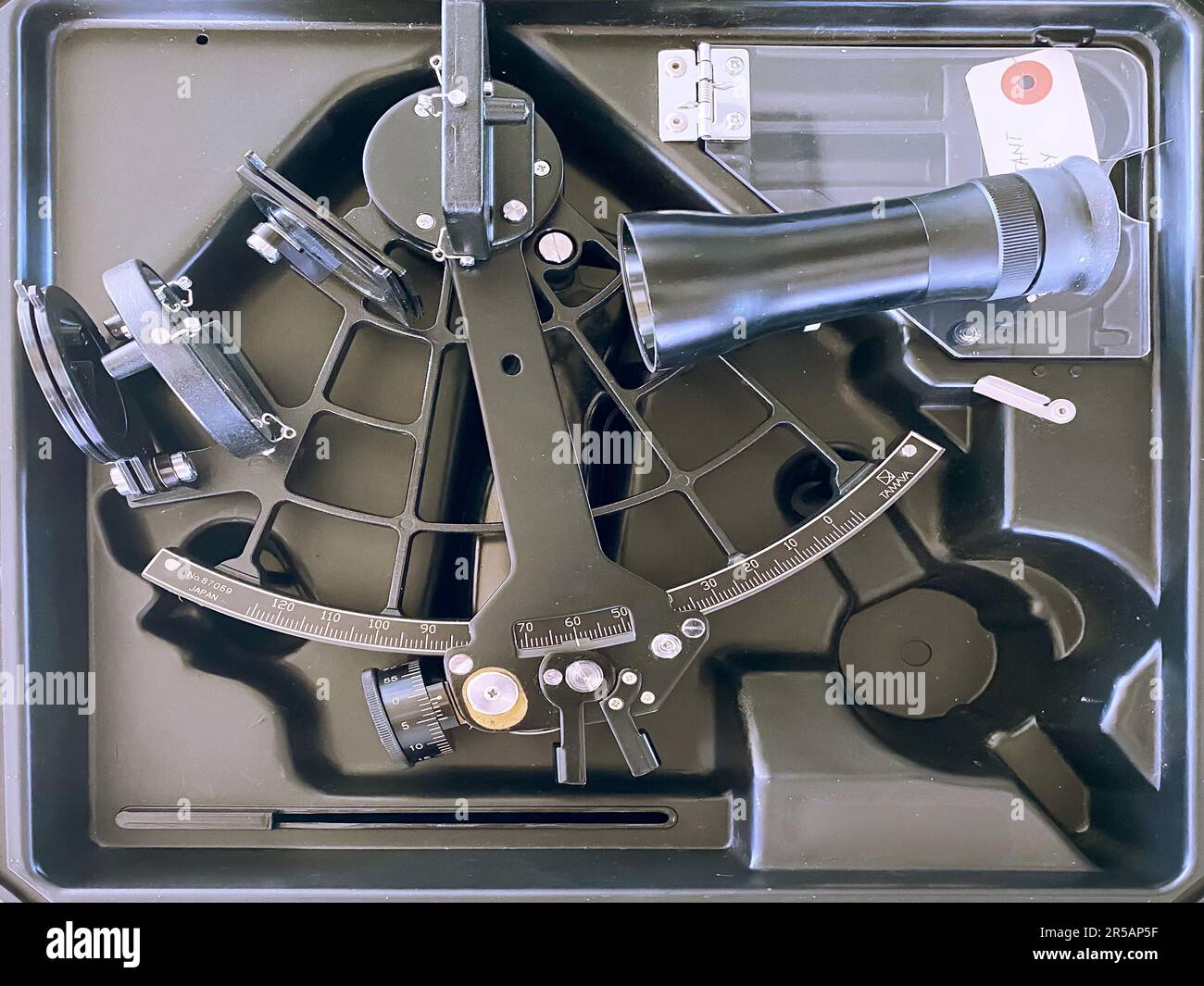 An aged, brass-plated nautical compass encased in a protective wooden ...