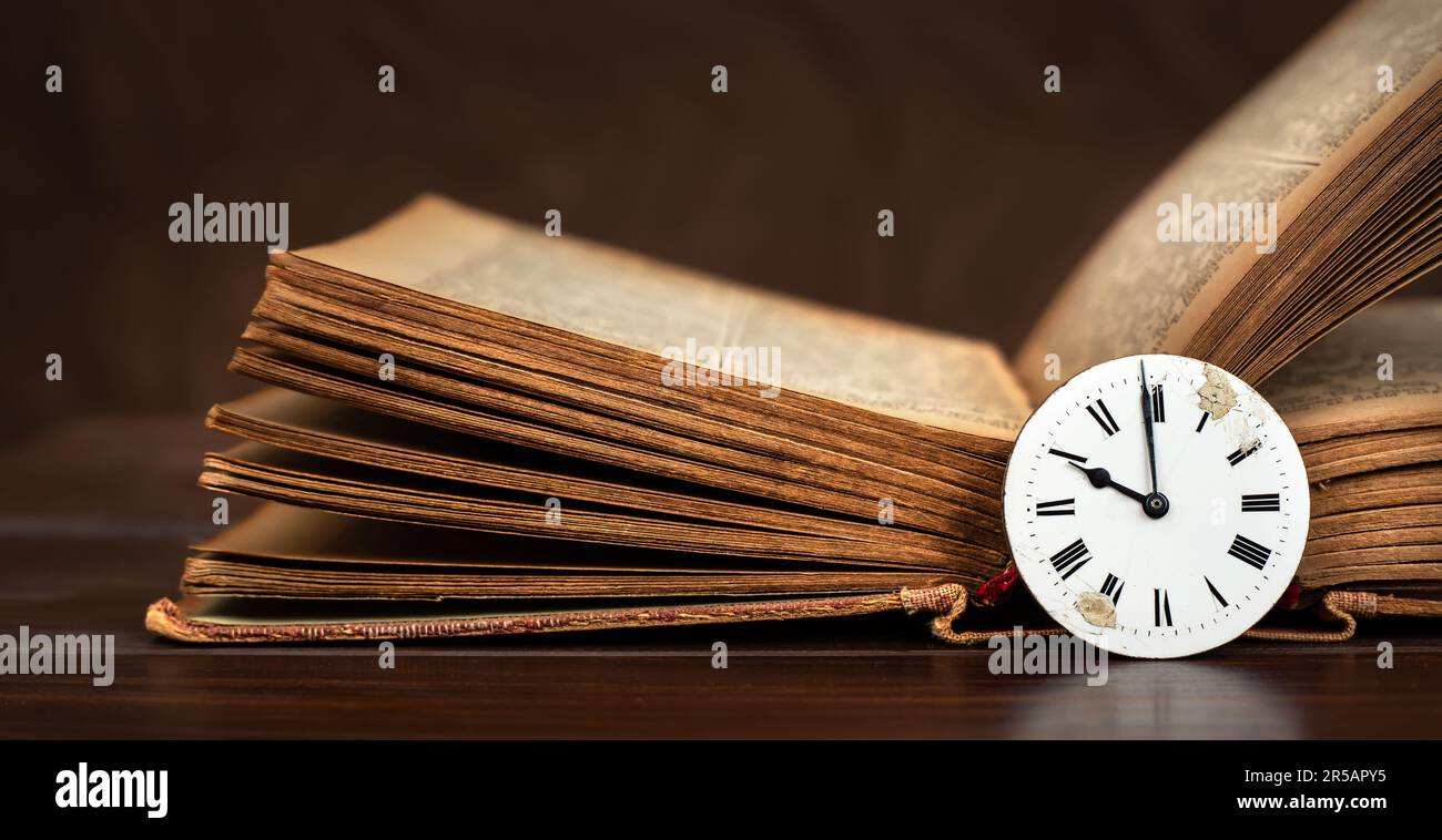 Old book and vintage clock with copy space. Story time, storytelling ...