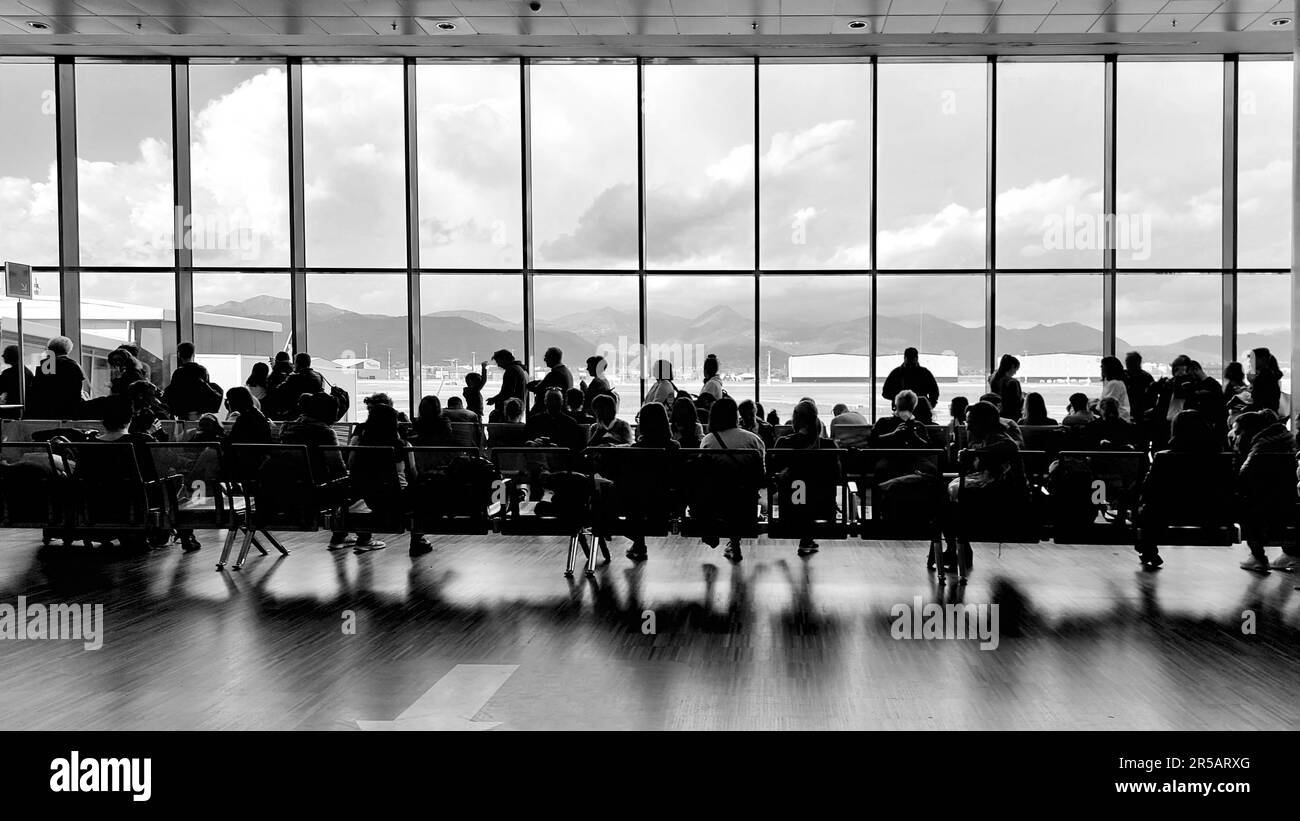 Passengers queuing at the airport waiting the gate. Tourists with ...