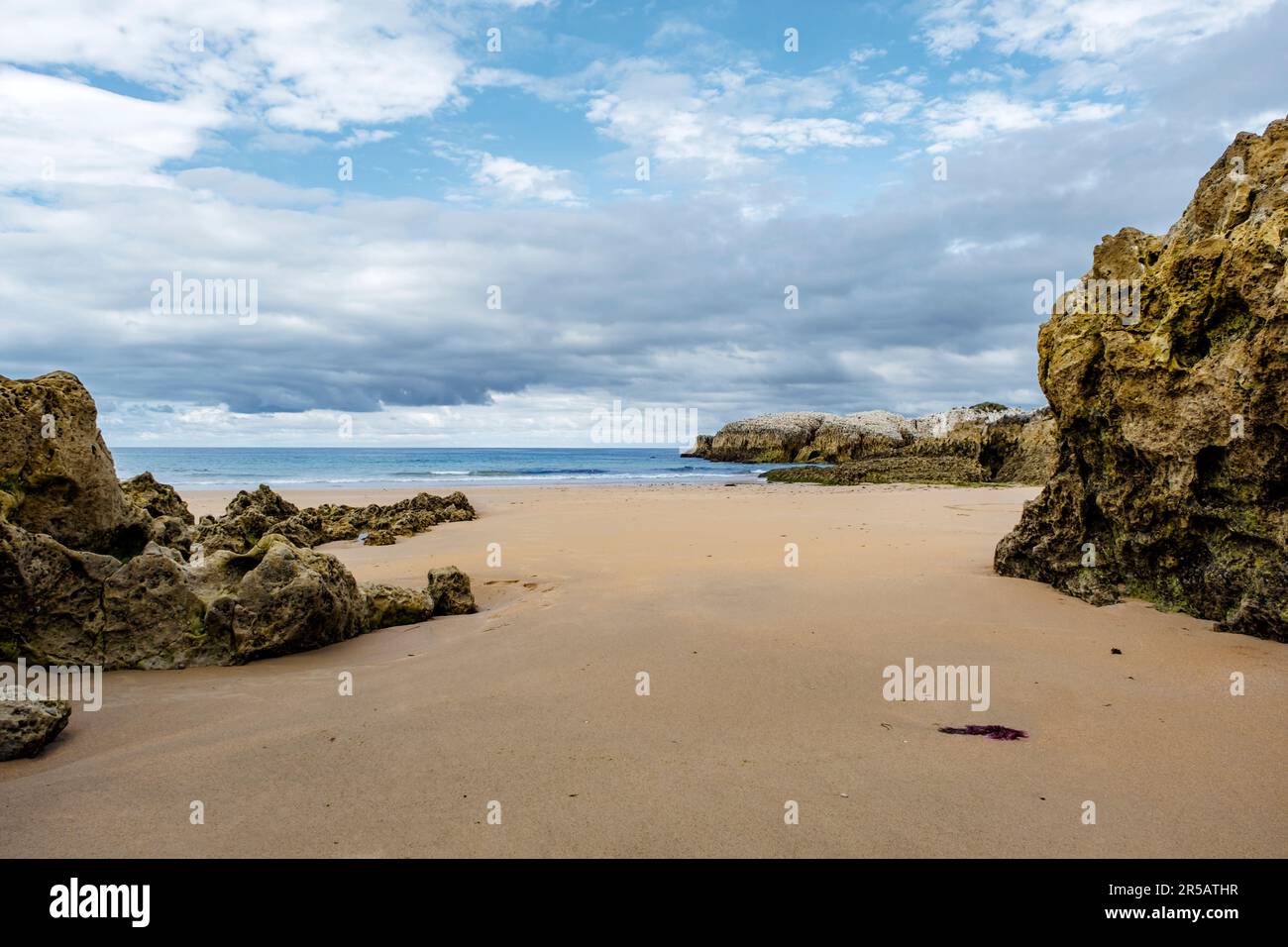 Beautiful and quiet sandy beach with sedimentary rocks outcrops in ...