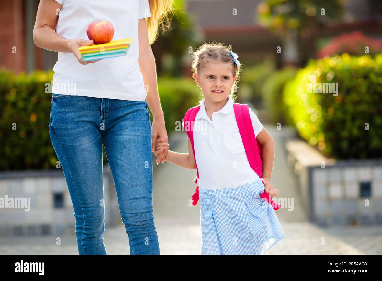 Mother and kids after school. Young mom picking up children after ...