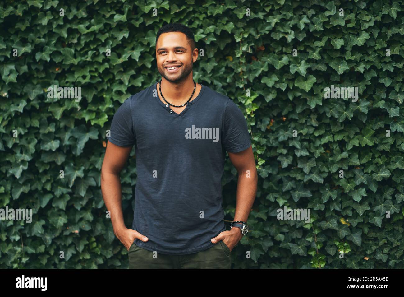 Outdoor portrait of young handsome african americam man, wearing black ...