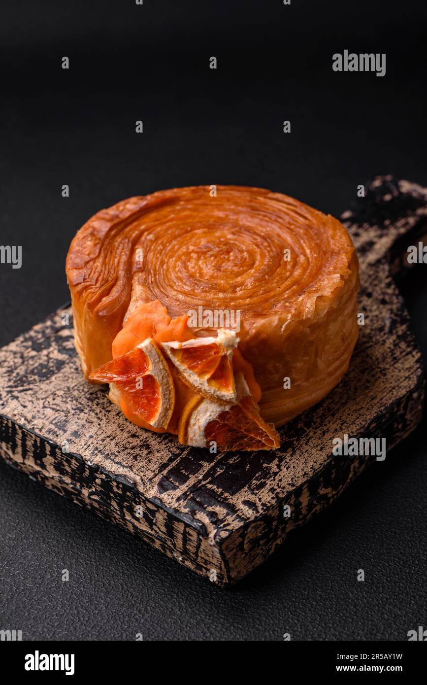 Round puff pastry croissant with citrus filling or New York roll on ...