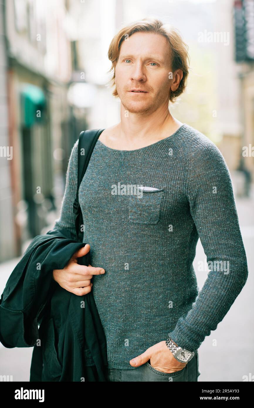 Outdoor fashion portrait of handsome red-haired man wearing blue ...