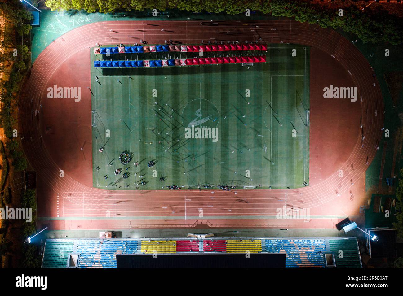 A vibrant image of a football stadium with a lush, green grass field ...