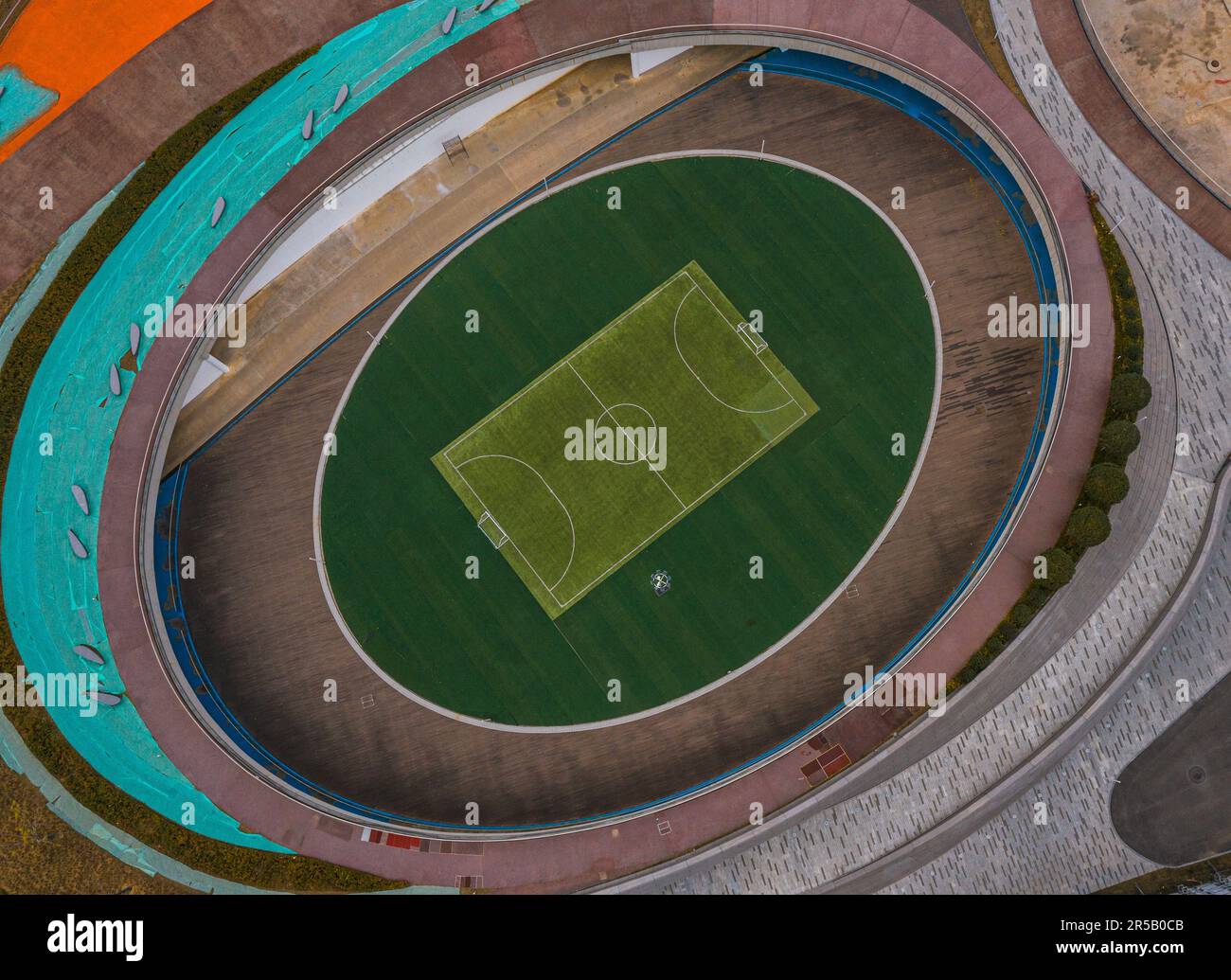 An aerial view of a pristine soccer field in a stadium with lush green ...