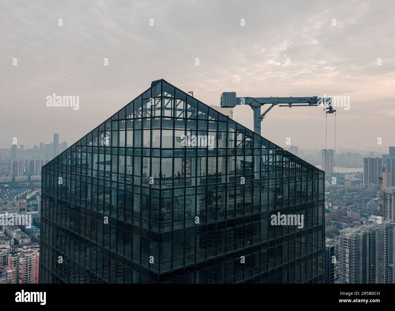 A modern city building with large windows providing a view of a ...