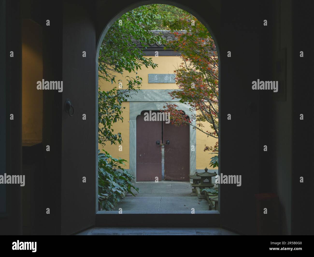 An open door is seen at the end of a dark, narrow hallway Stock Photo ...