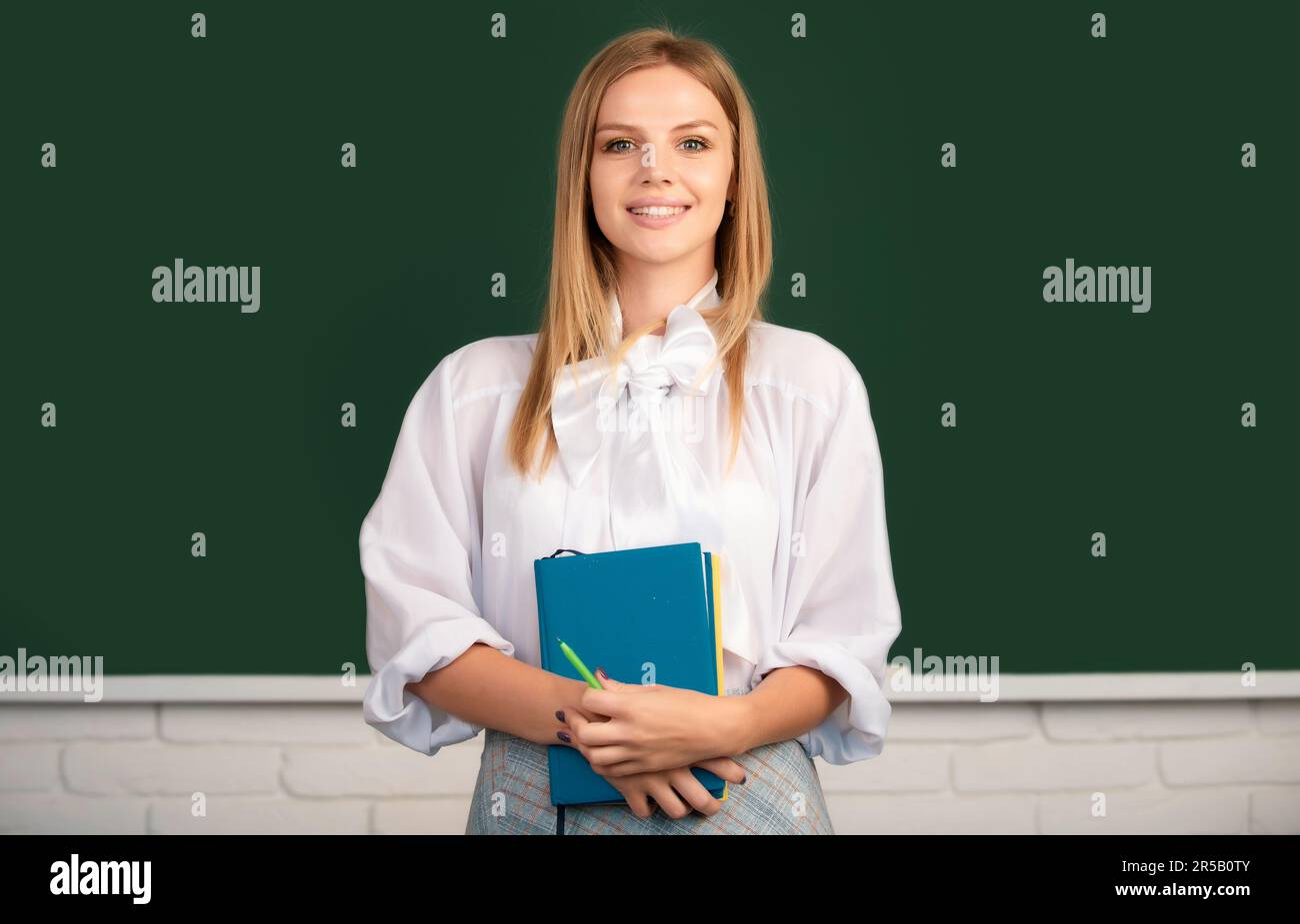 Back to school. Portrait of a young woman student with laptop in a ...