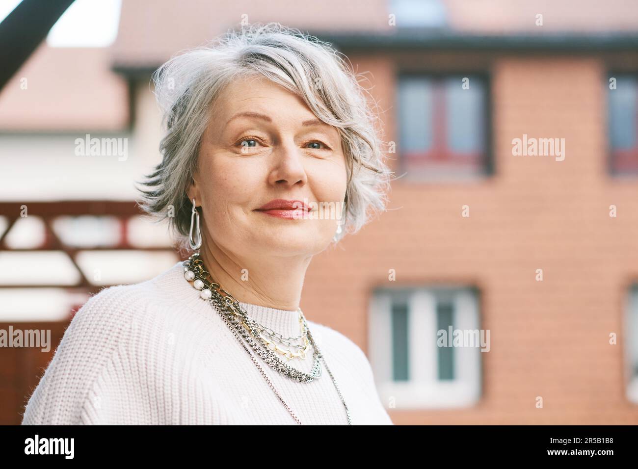Outdoor close up portrait of beautiful 55 - 60 year old woman Stock Photo - Alamy