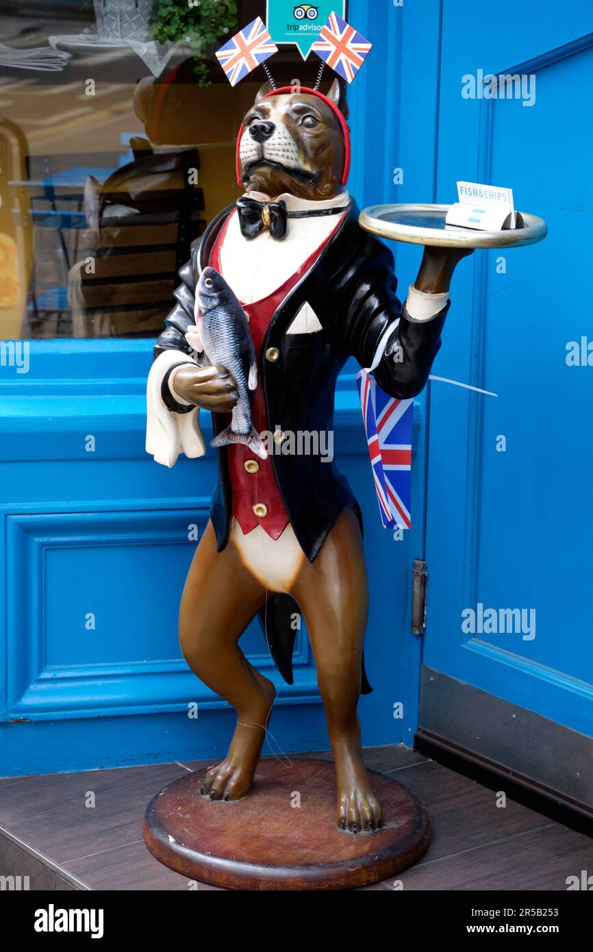 Dog statue at fish and chips restaurant with british flags,London Stock ...
