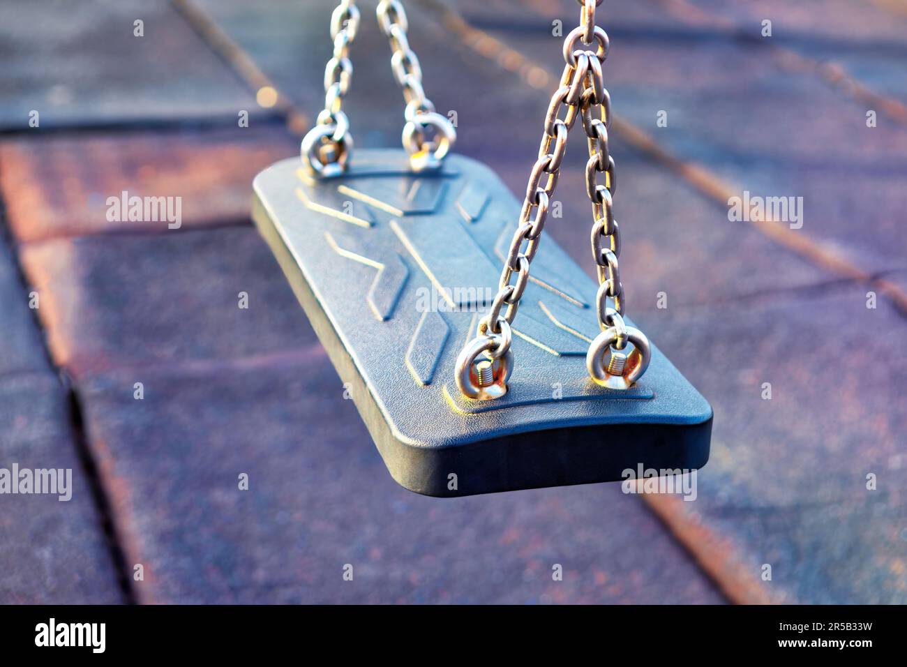 Traditional Swing With Chains . Childrens swing on a playground Stock ...