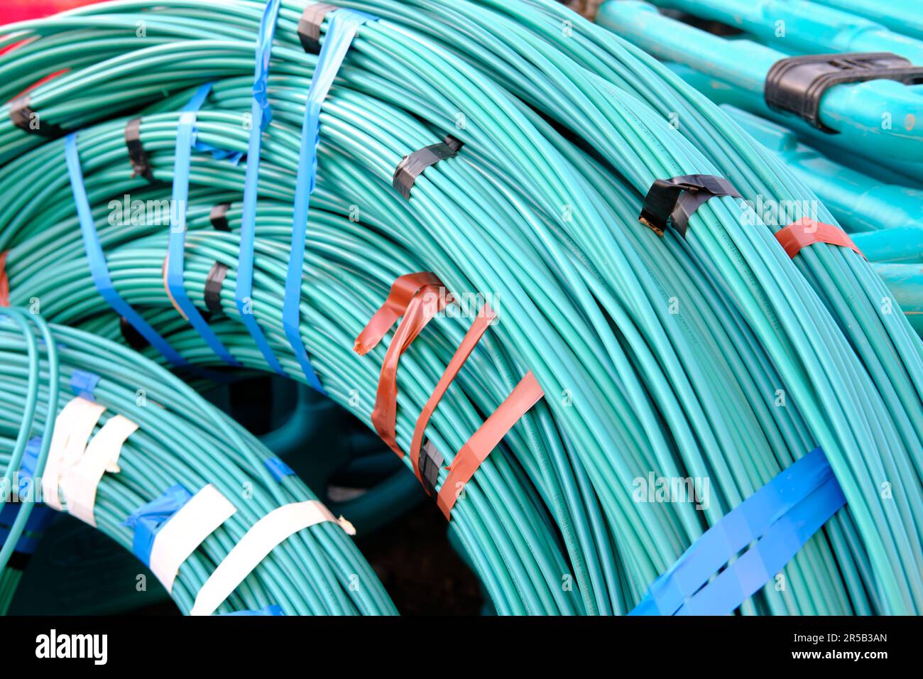 Rolls of light blue underground fibre optic cable Stock Photo - Alamy