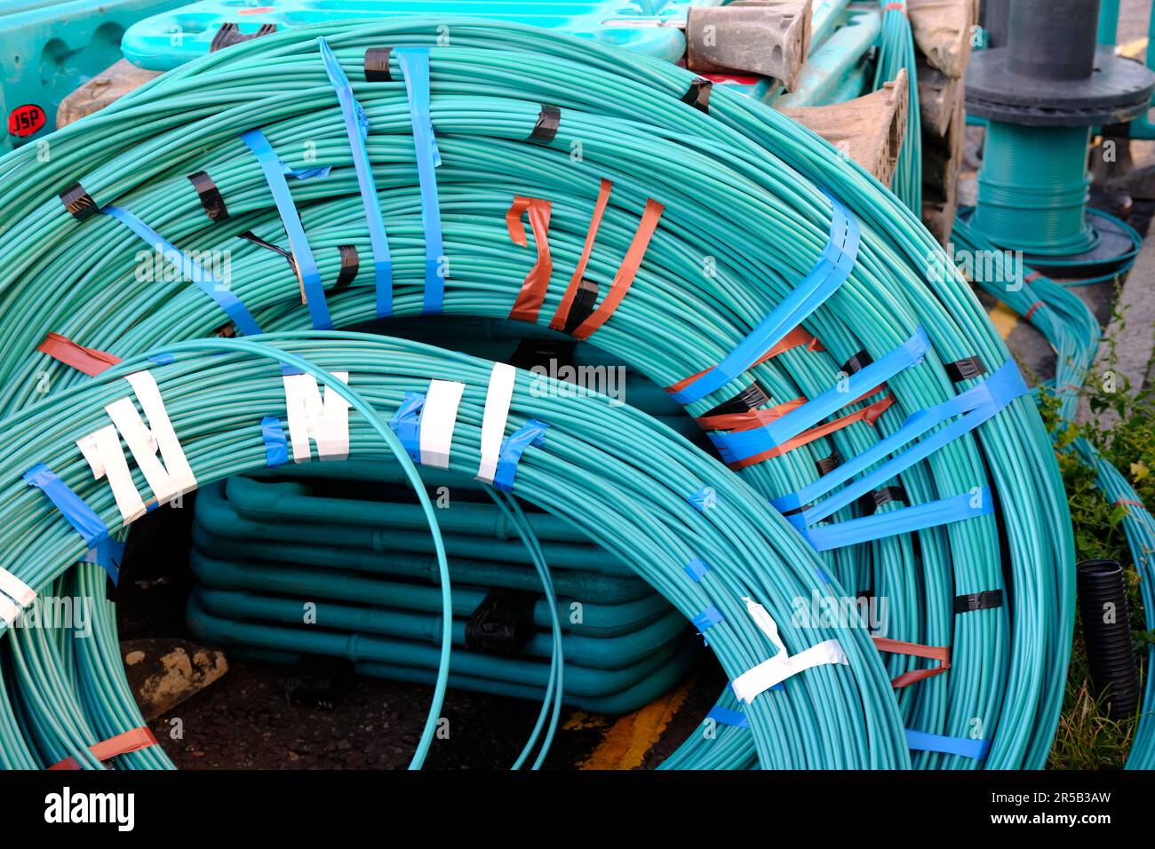 Rolls of light blue underground fibre optic cable Stock Photo - Alamy