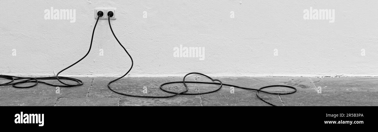 A grayscale shot of two electrical wiring in a hall Stock Photo - Alamy