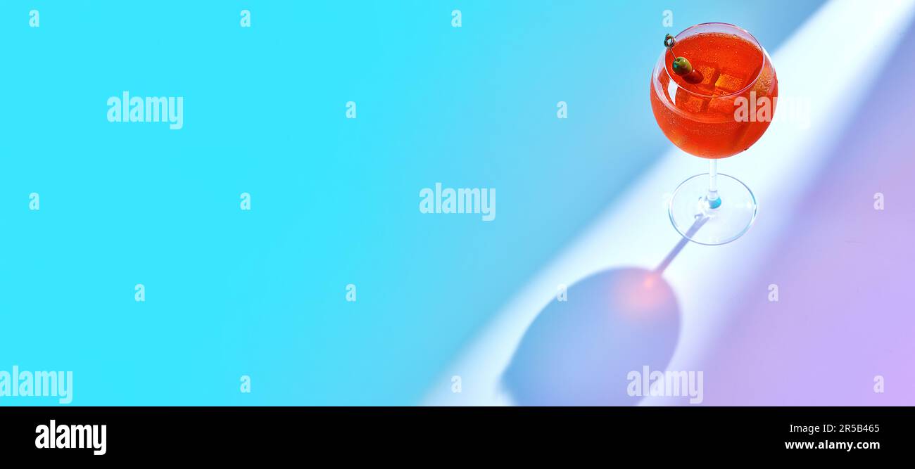Classic italian aperol spritz cocktail over gradient blue neon ...