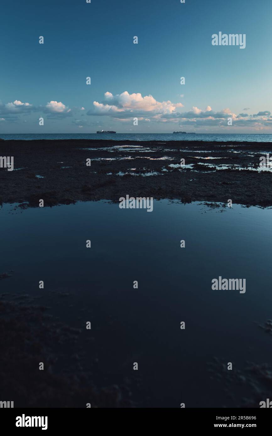 Magical sunset reflecting clouds on the ocean's surface seen from a ...