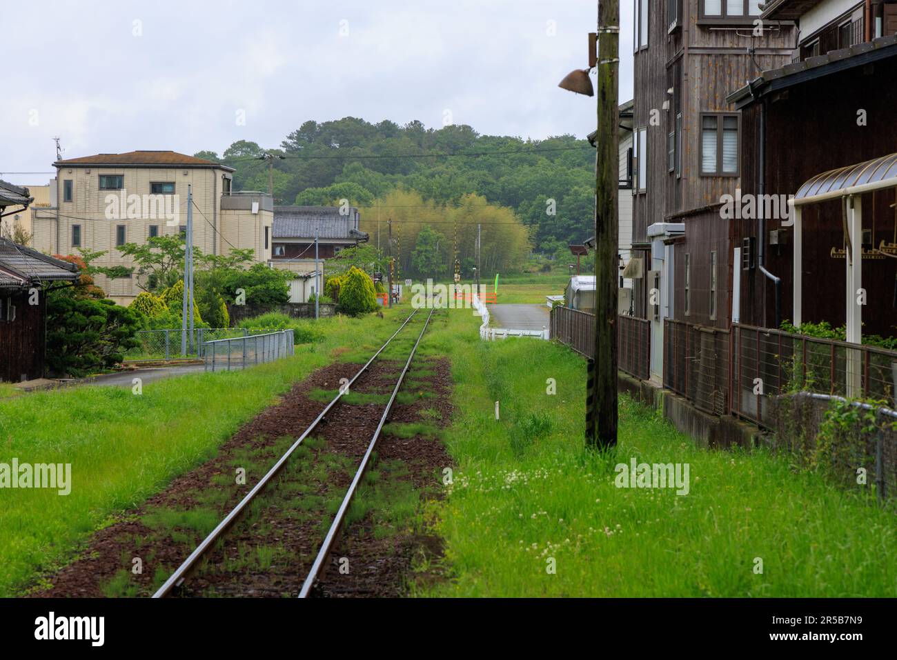 Train tracks by buildings in rural Japanese town Stock Photo - Alamy