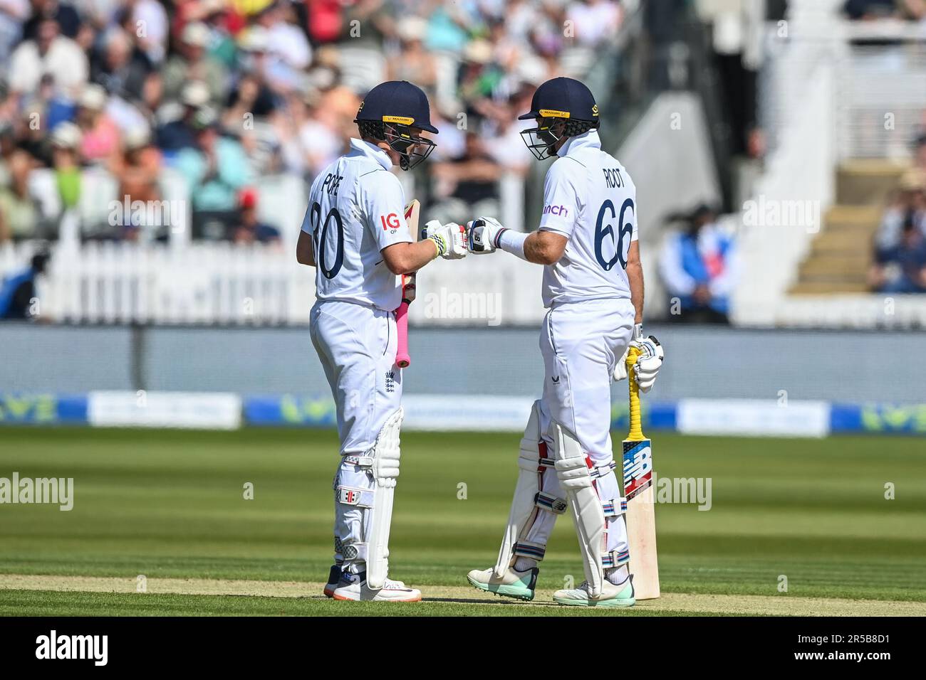 Joe Root of England fist bumps Ollie Pope of England after he reaches ...