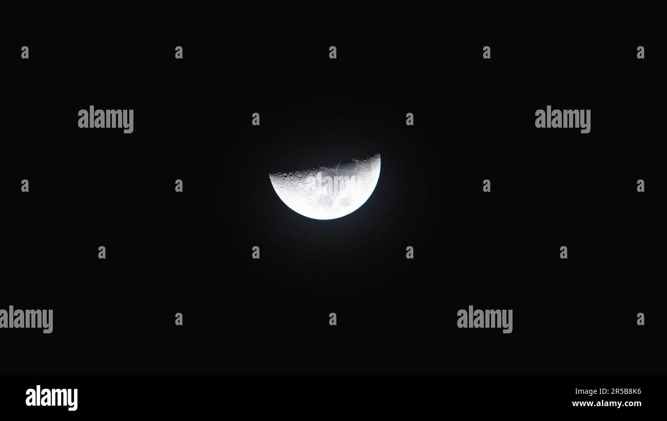 A celestial scene of a glowing full moon illuminated in a star-filled ...