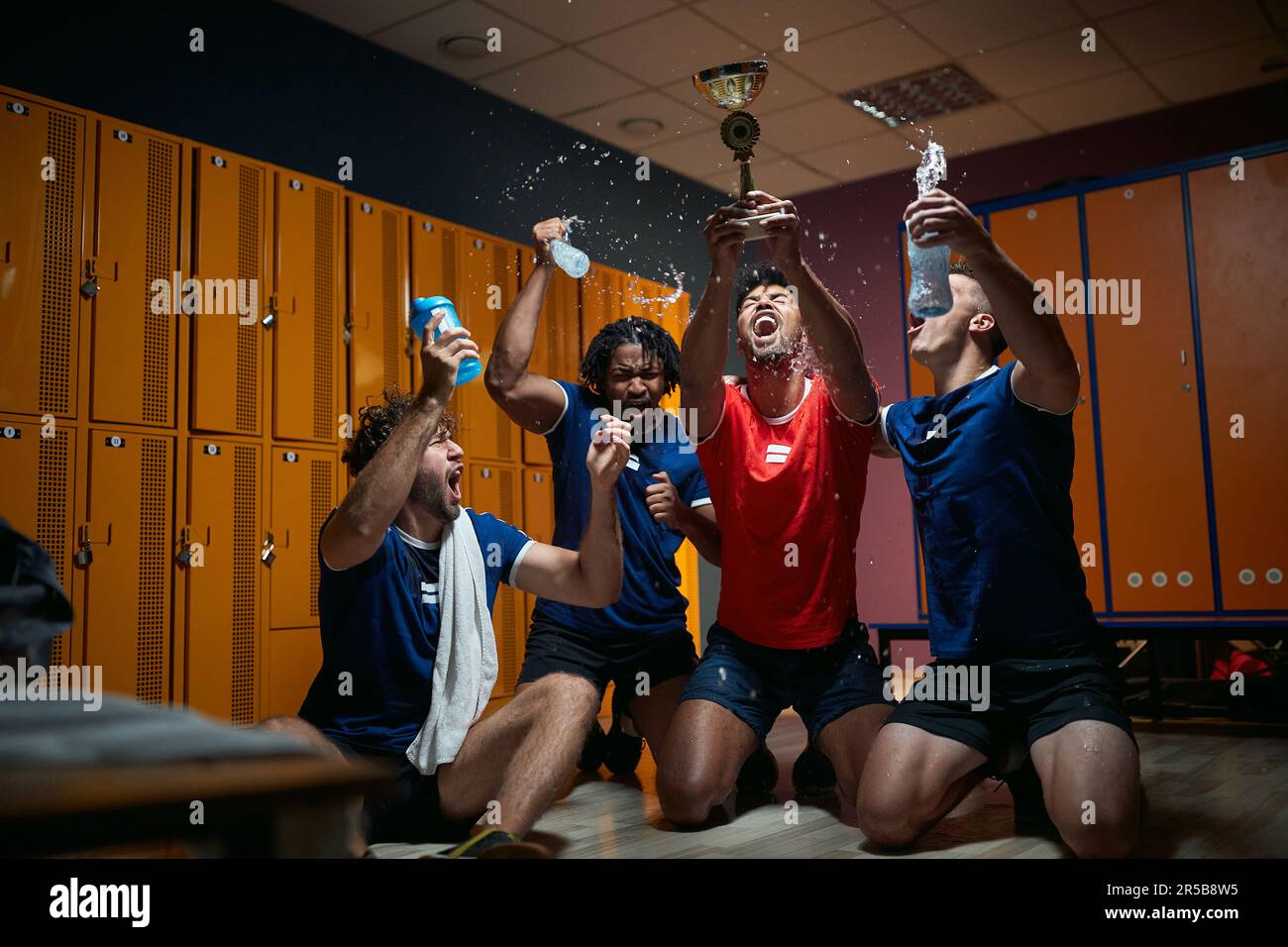 Sports team celebrating success. Group of men players holding golden ...