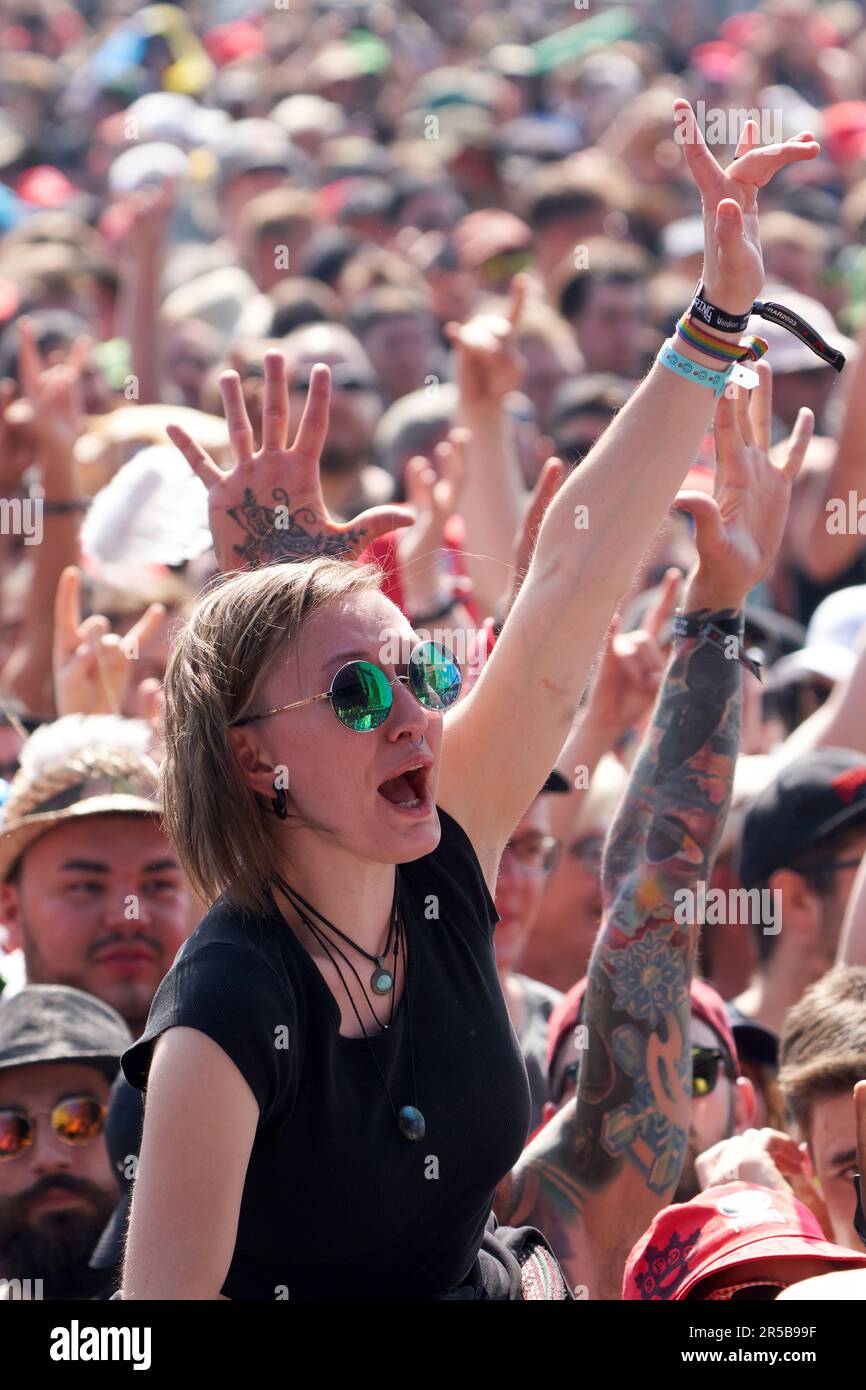 02 June 2023, Rhineland-Palatinate, Nürburg: Rock fans dance during the ...