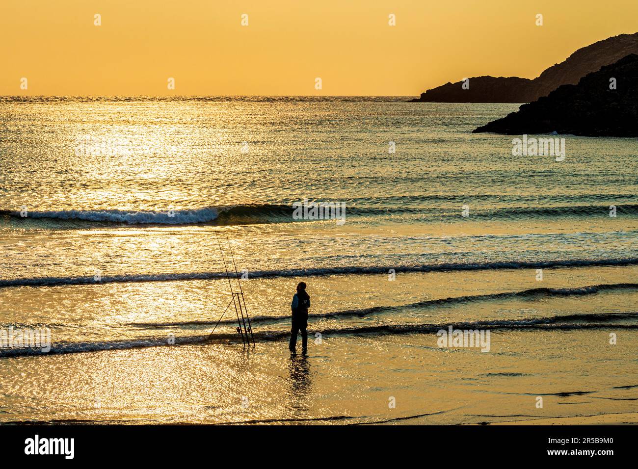 Sea angler beach casting at sunset, Whitesands Bay, a Blue Flag beach ...