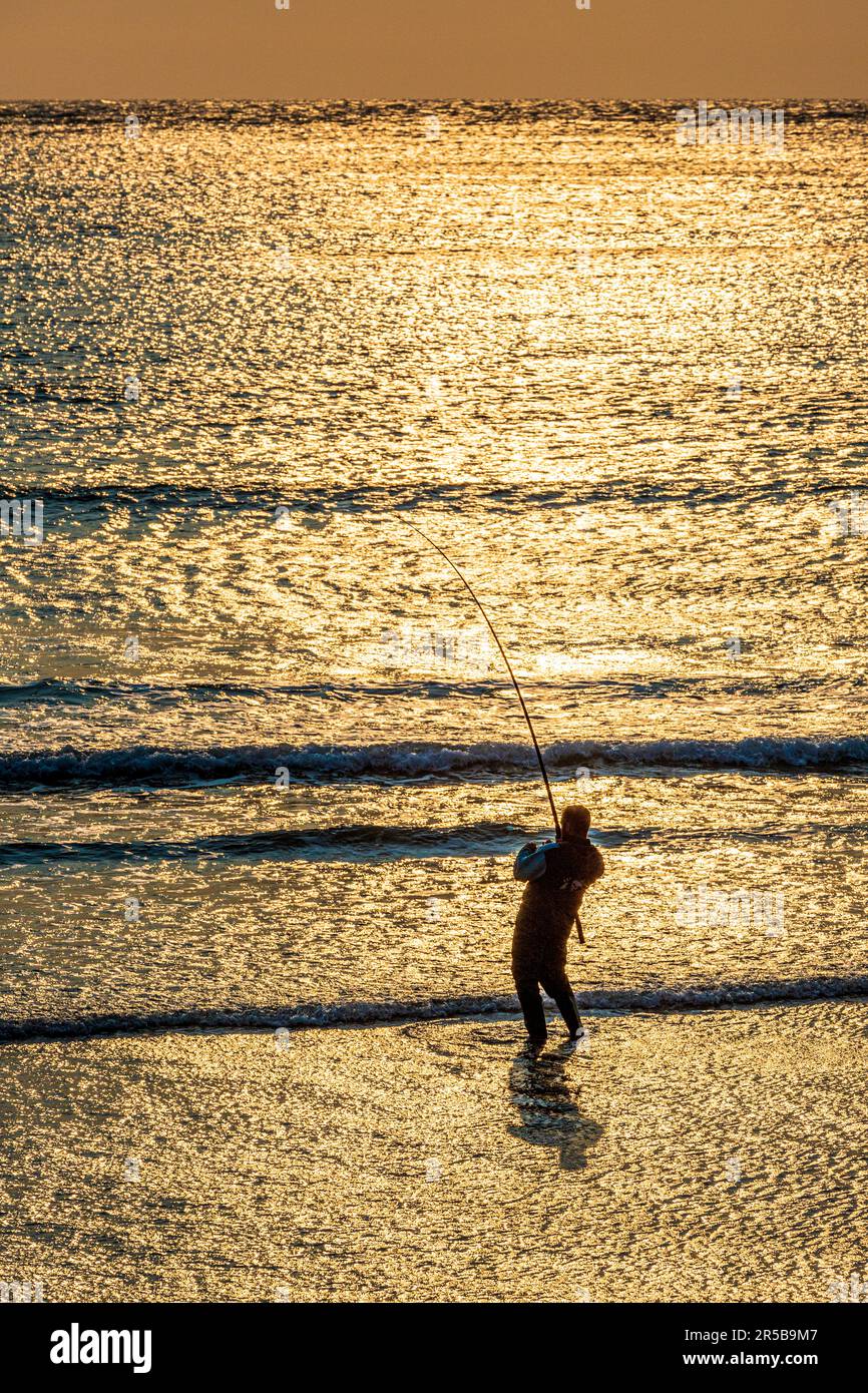 Sea angler beach casting at sunset, Whitesands Bay, a Blue Flag beach ...