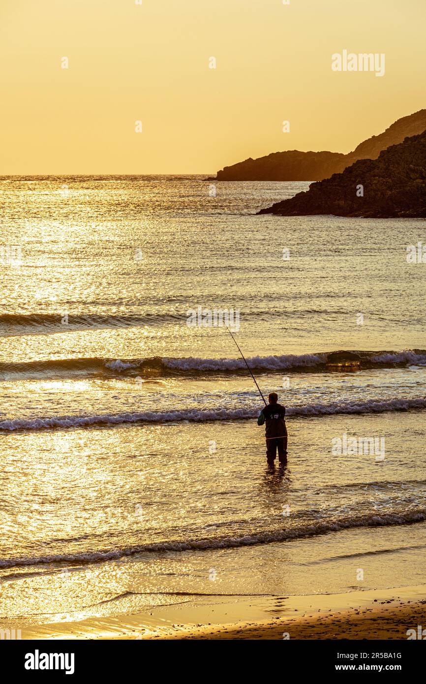 Sea angler beach casting at sunset, Whitesands Bay, a Blue Flag beach ...