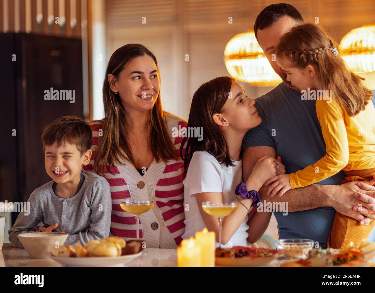 Big happy family is having lunch in dining room. Parents and children ...