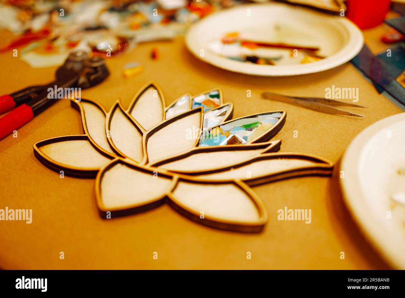 Master class of mosaic art. Closeup of mosaic in shape of lotus flower ...