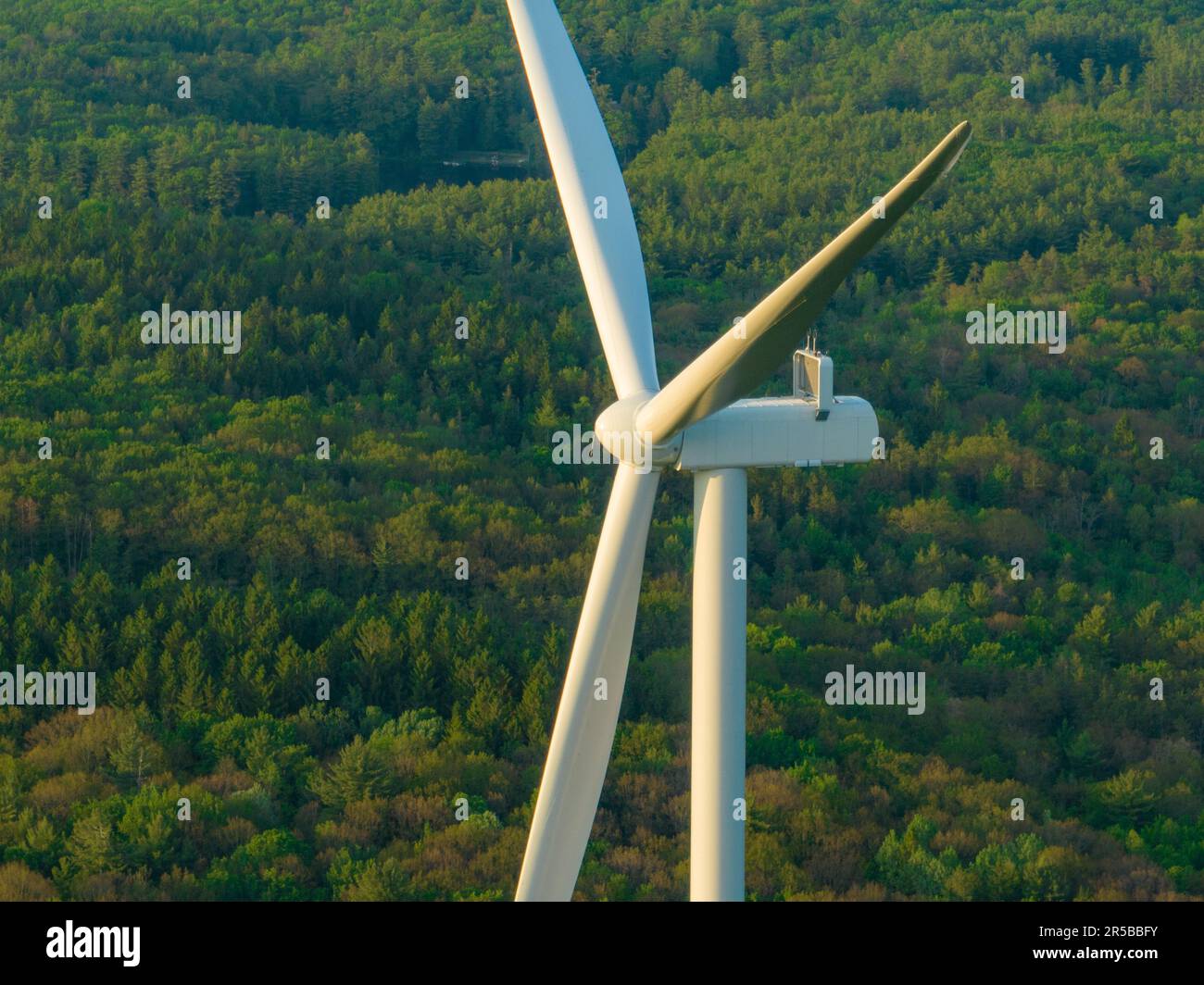 Afternoon aerial drone view of wind power turbines under construction ...