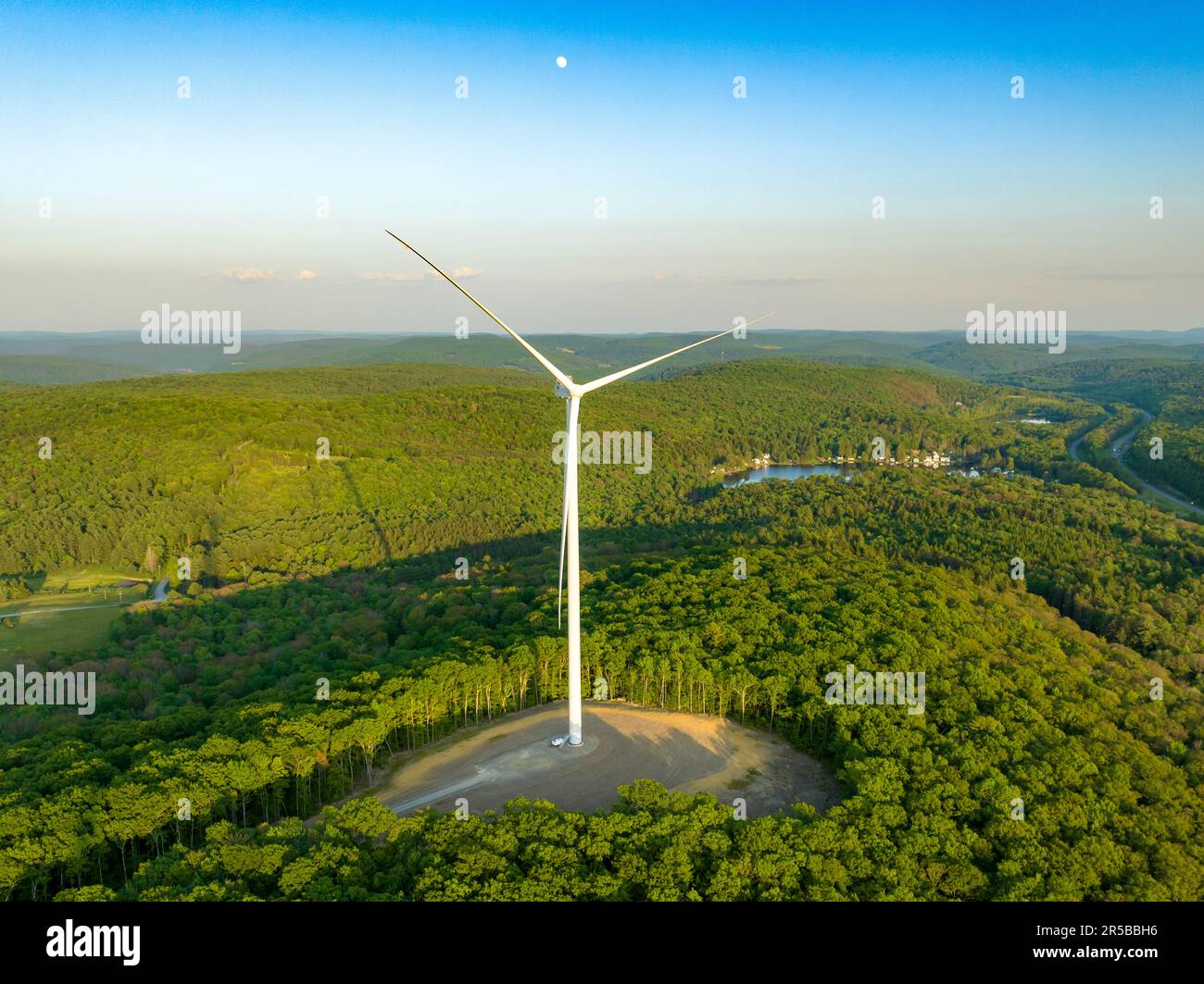 Afternoon aerial drone view of wind power turbines under construction ...