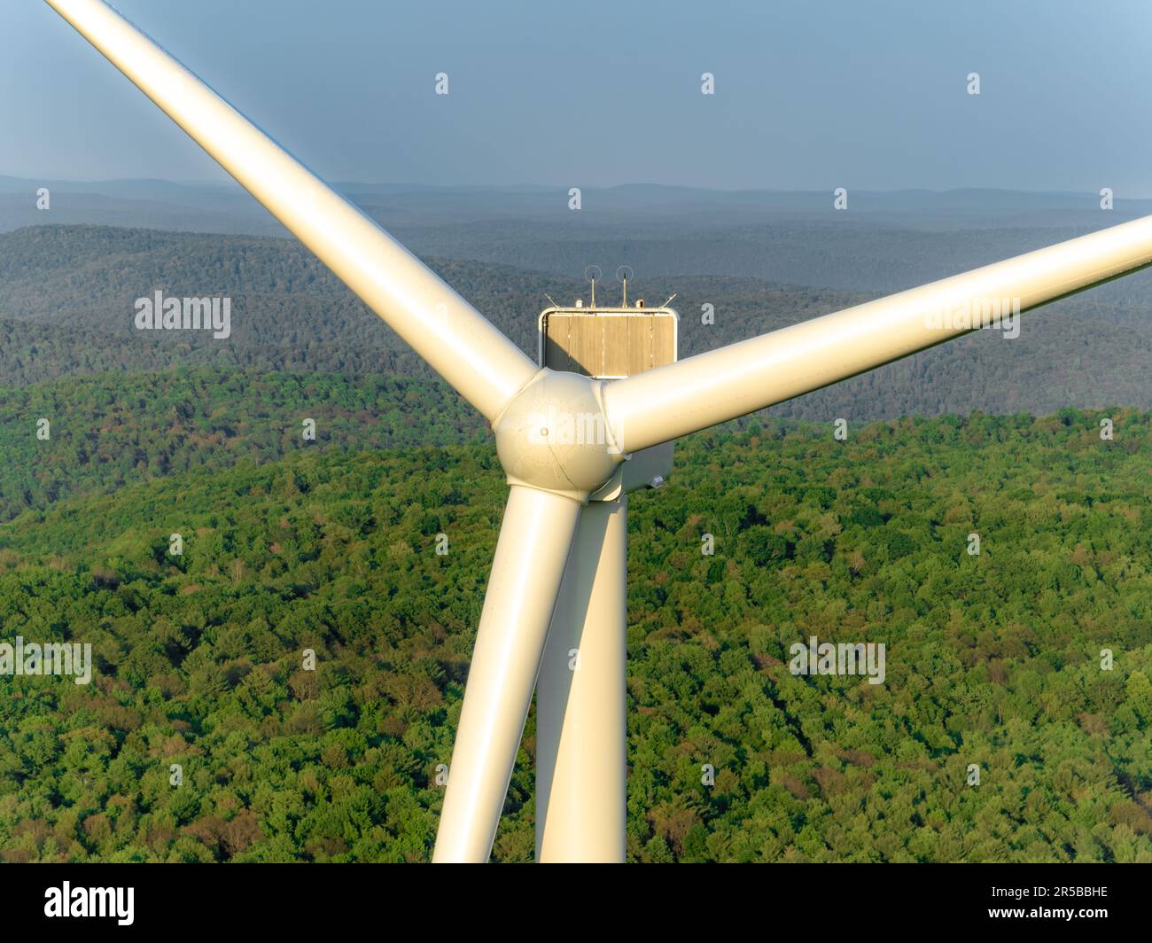 Afternoon aerial drone view of wind power turbines under construction ...