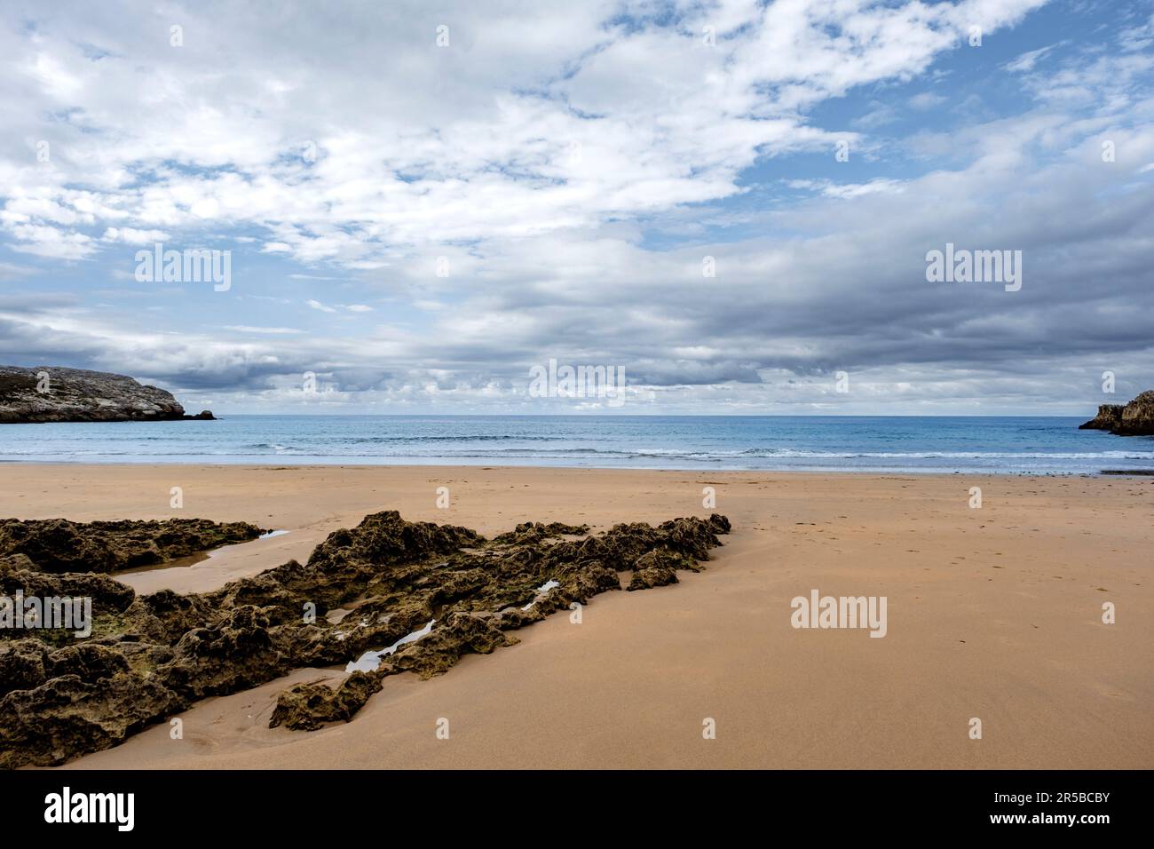 Beautiful and quiet sandy beach with sedimentary rocks outcrops in ...